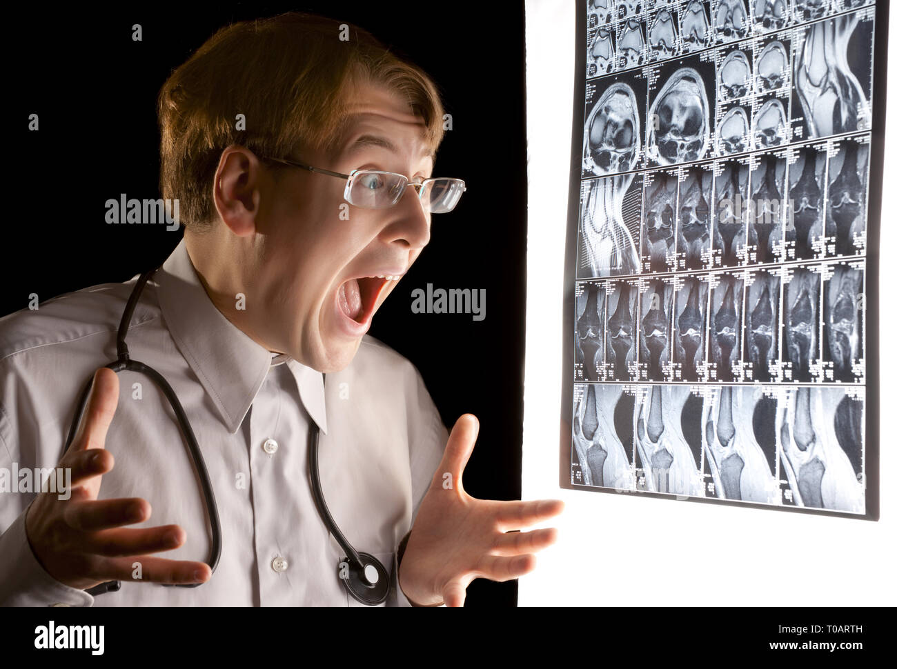 Doctor looking at the MRI scan and crying in panic Stock Photo - Alamy