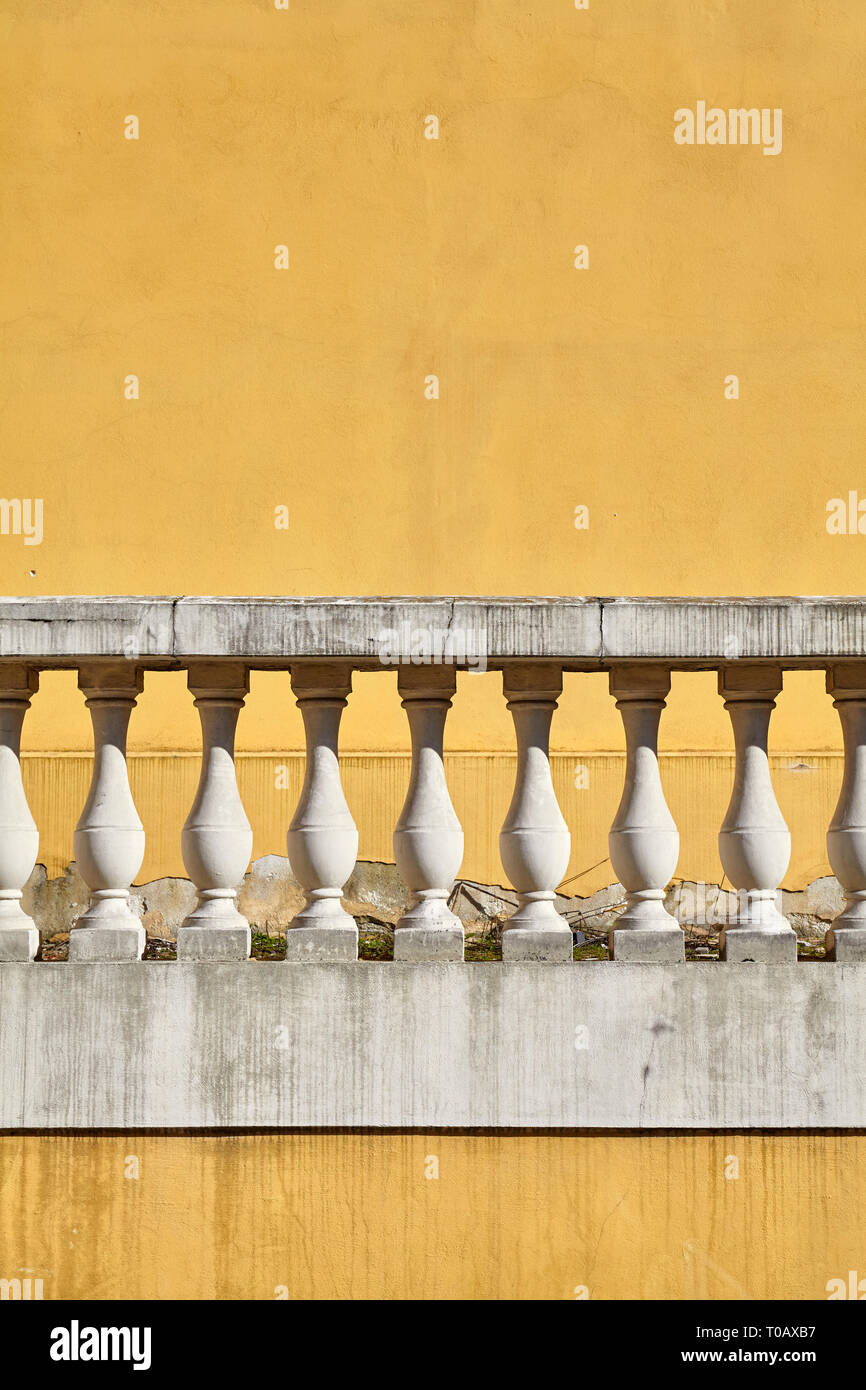 Old balustrade against yellow wall, architectural background Stock ...