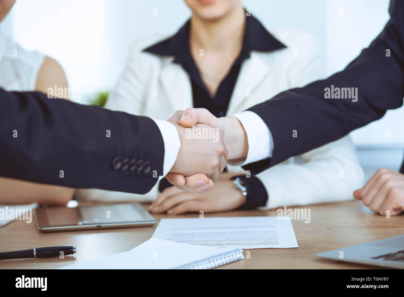 Business people shaking hands at meeting or negotiation in the office ...