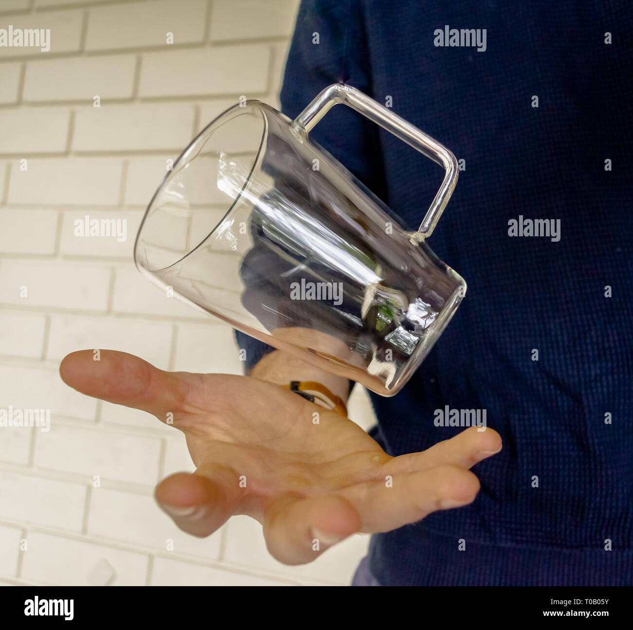 floating glass over hand Stock Photo - Alamy