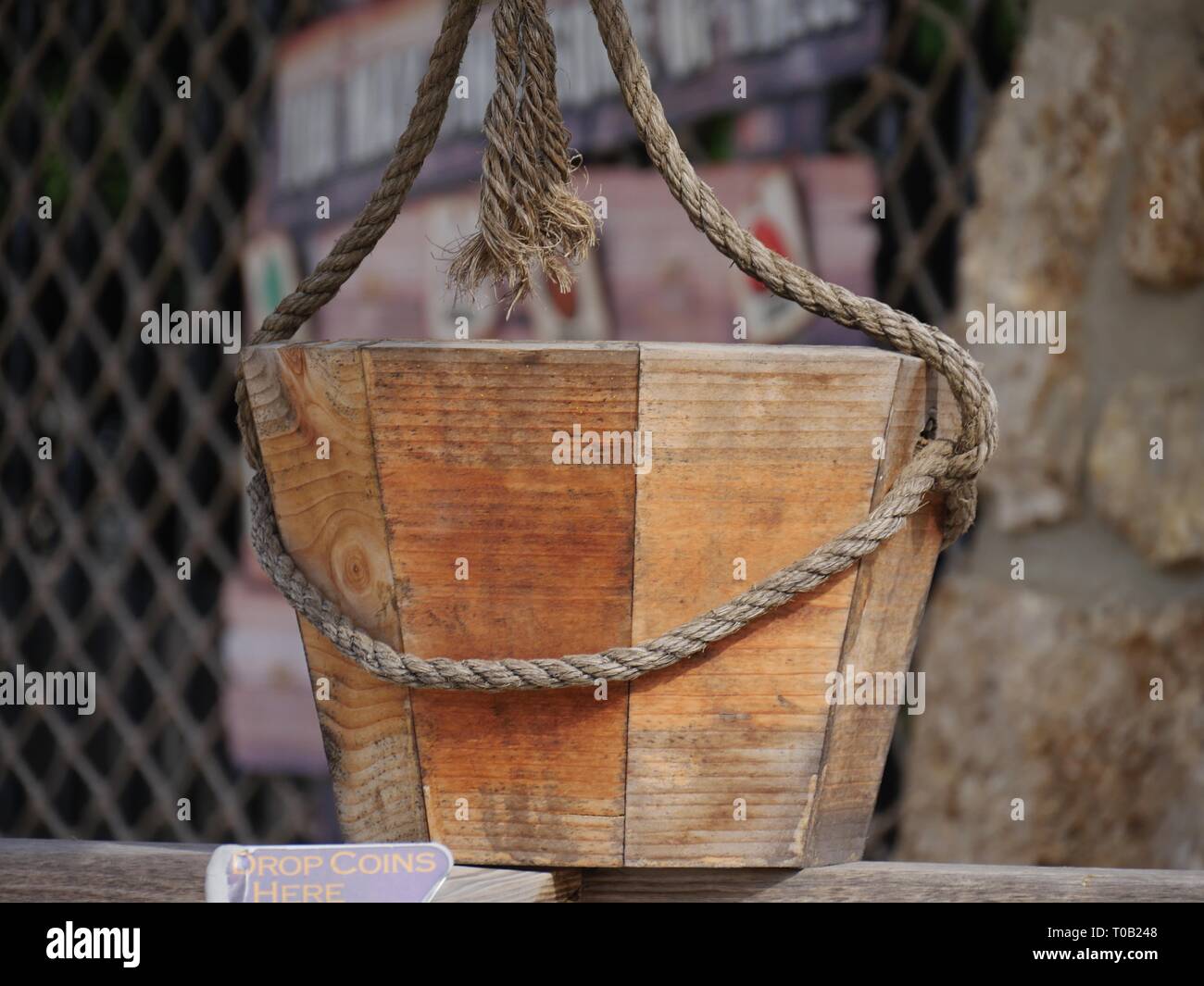 Wooden bucket with a braid of rope tied to it hi-res stock photography ...