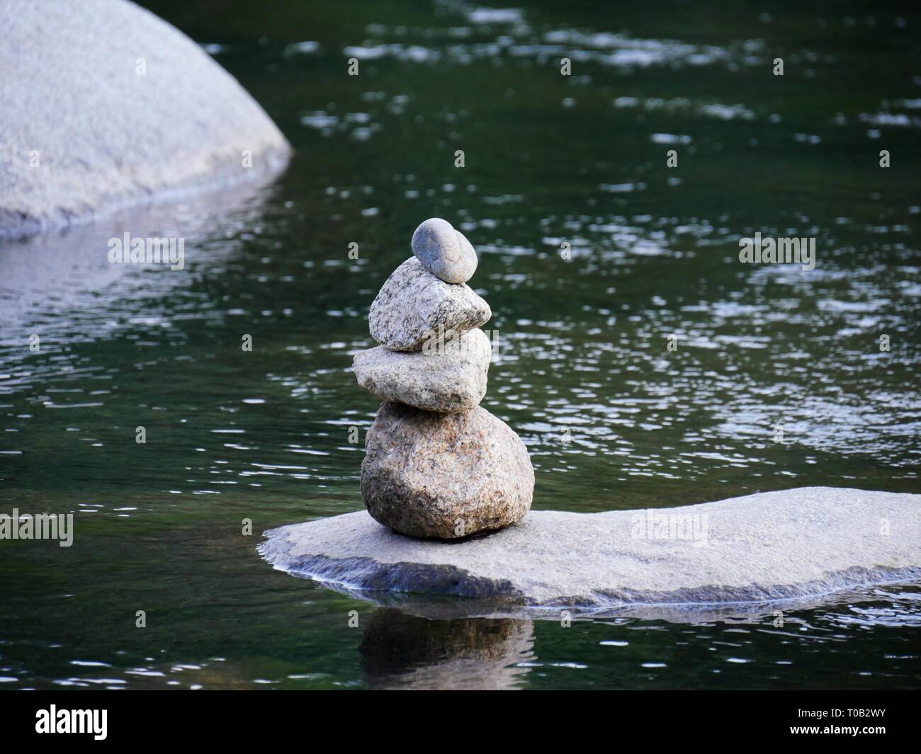 Close up of a stack of stones on top of a big rock in the river Stock ...