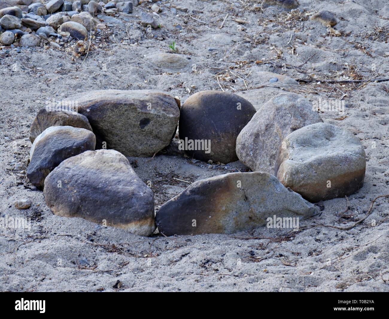 Ring of stones used for a camp fire in the sand Stock Photo - Alamy