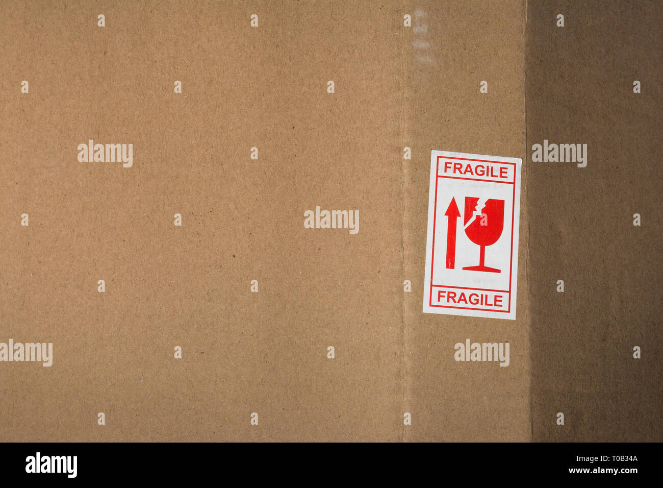 'FRAGILE' label on the side of a cardboard carton / box. Broken glass ...