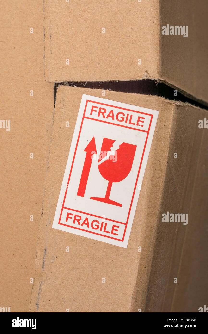 'FRAGILE' label on the side of a cardboard carton / box. Broken glass ...