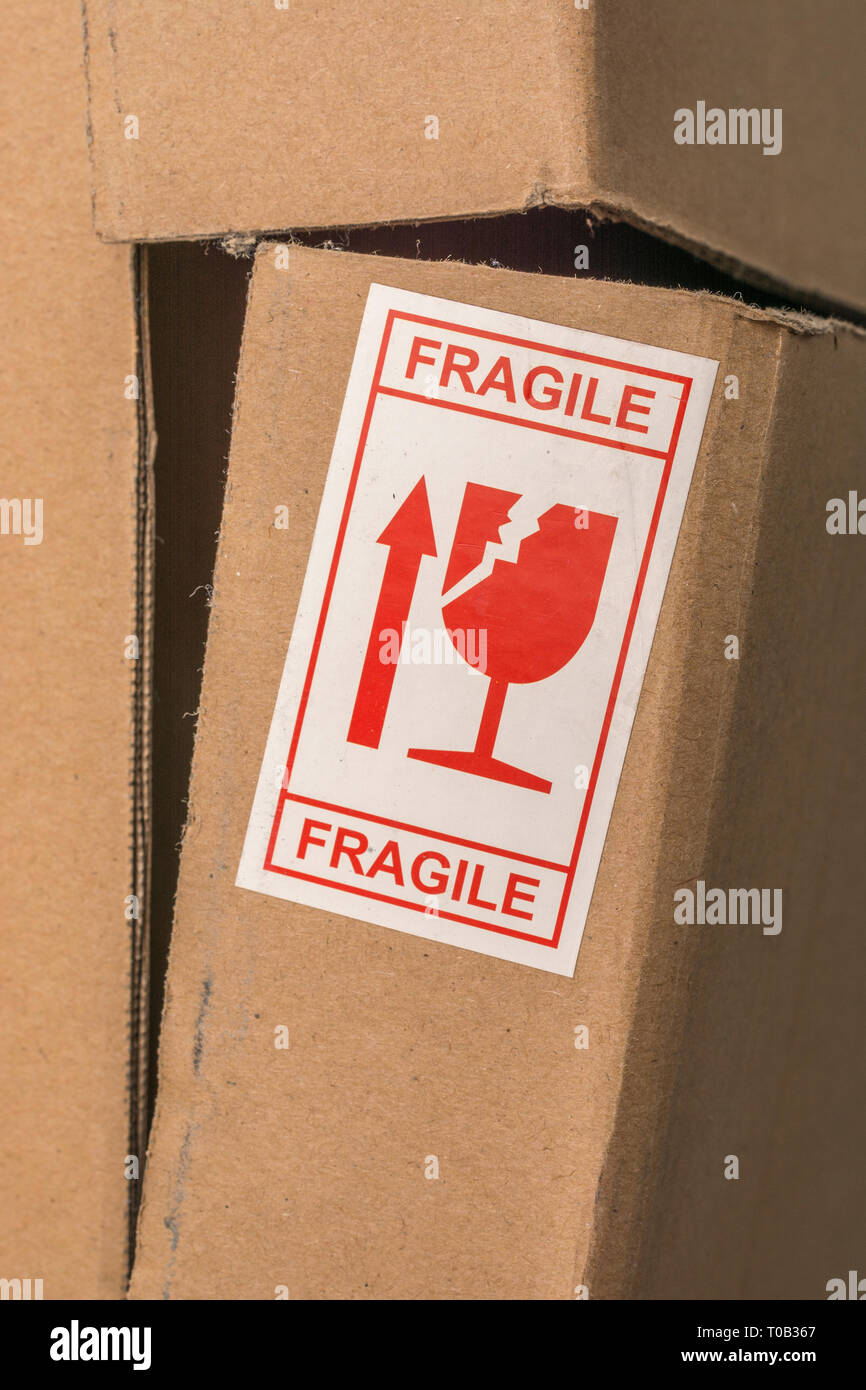 'FRAGILE' label on the side of a cardboard carton / box. Broken glass ...