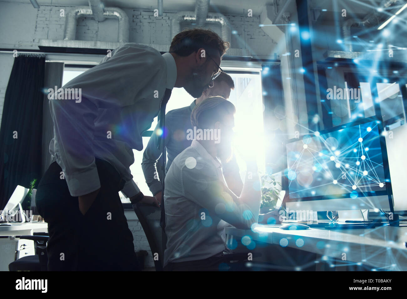 Teamwork works with a computer. Concept of internet sharing and ...