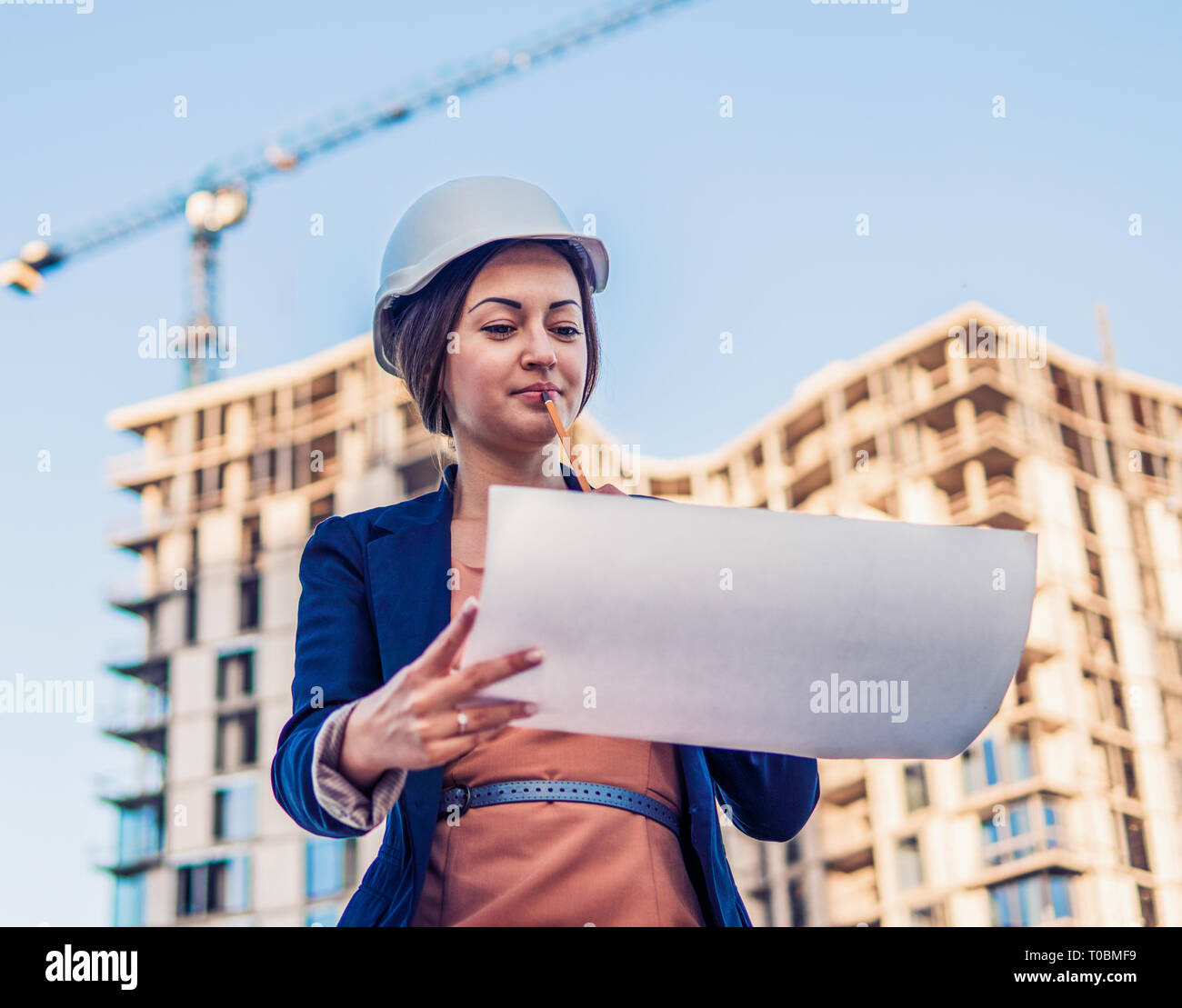 beatiful business woman engineer is standing with plan papers Stock ...