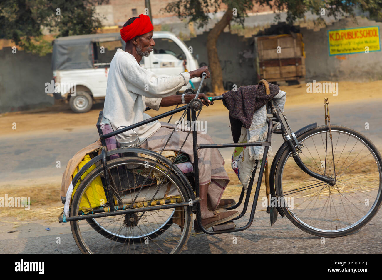 Indian man riding a tricycle Stock Photo - Alamy