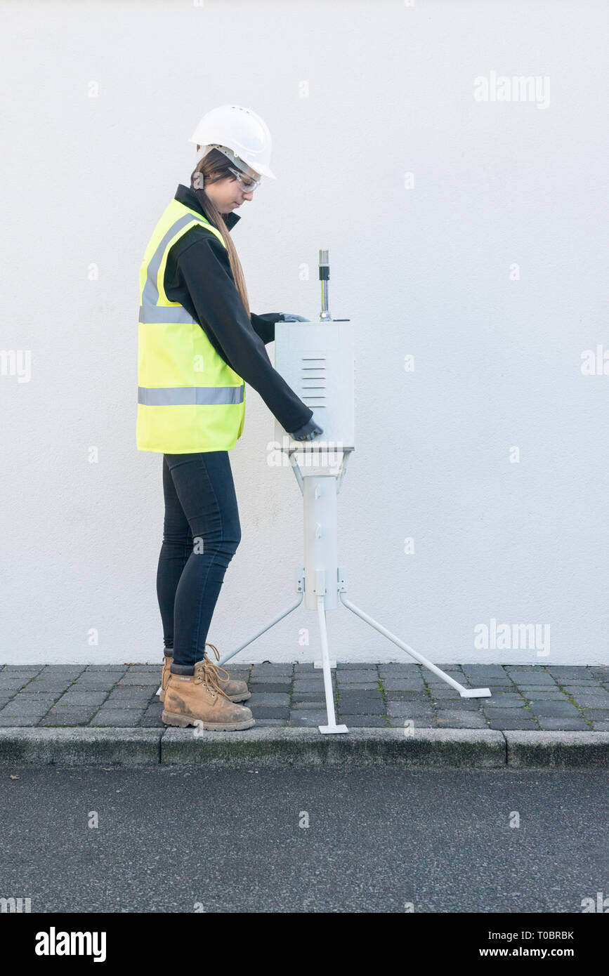 A female environmental construction worker uses specialist testing ...