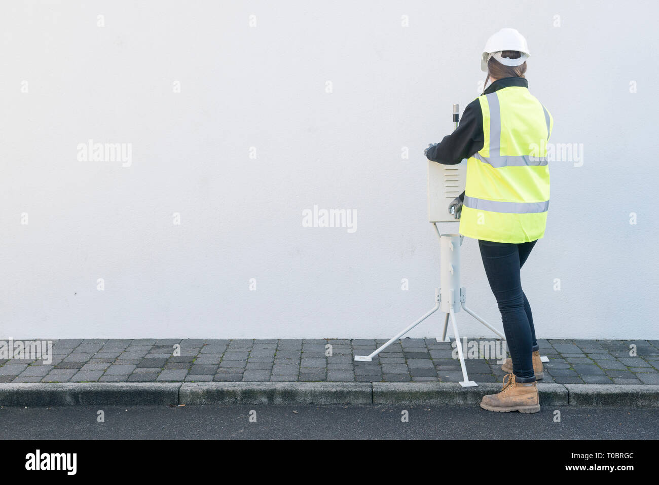 A female environmental construction worker uses specialist testing ...