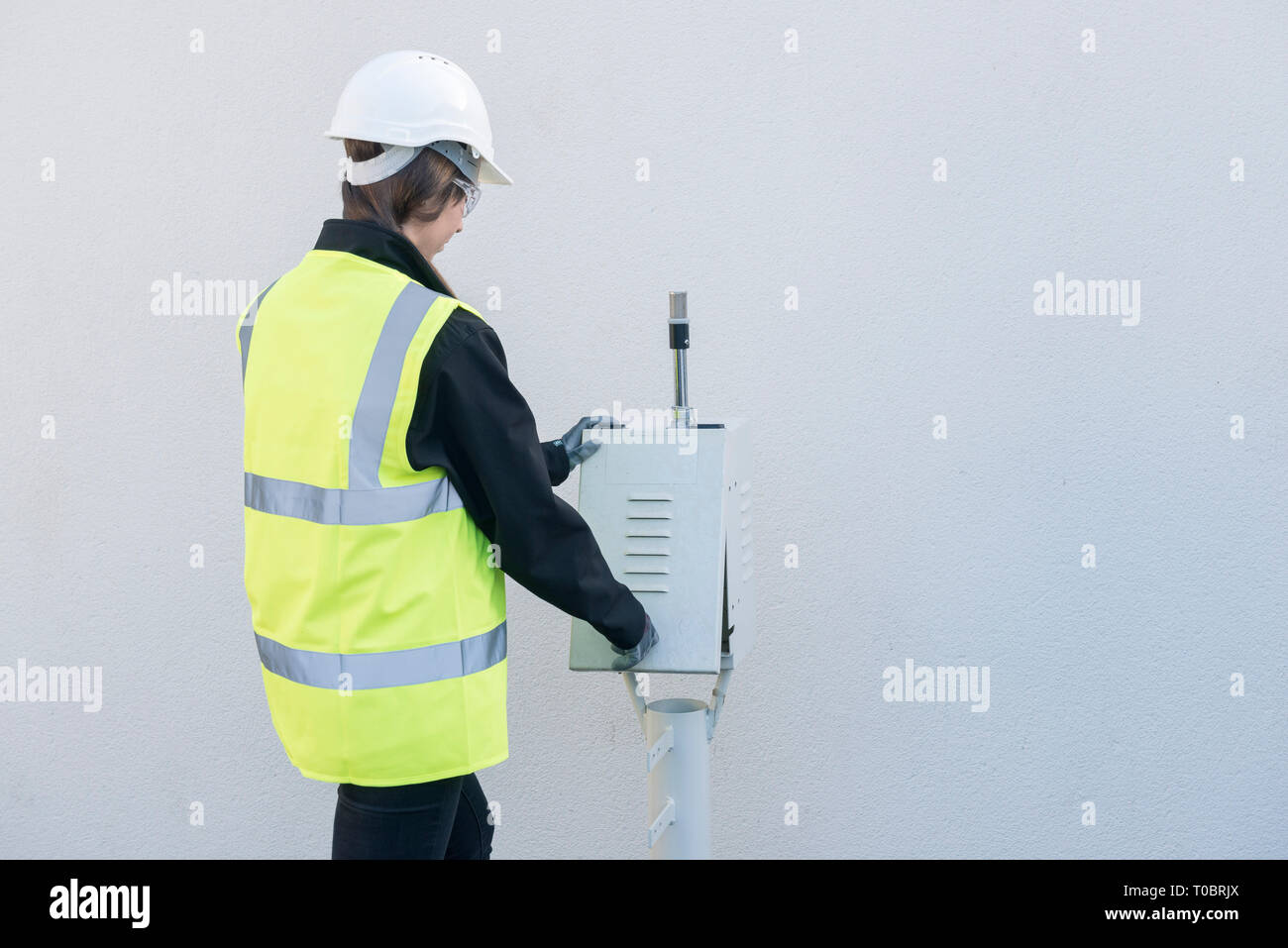 A female environmental construction worker uses specialist testing ...