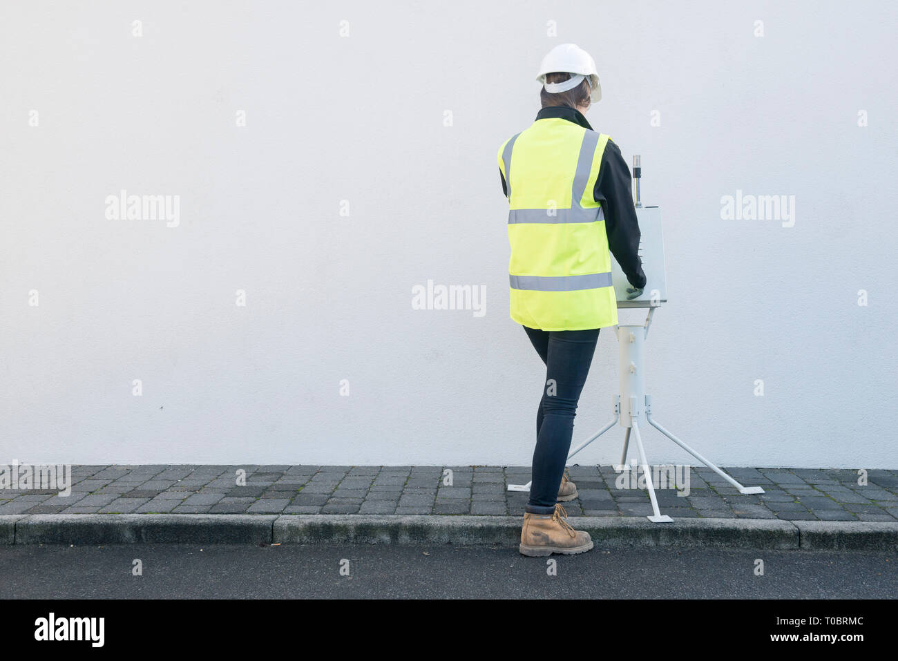A female environmental construction worker uses specialist testing ...