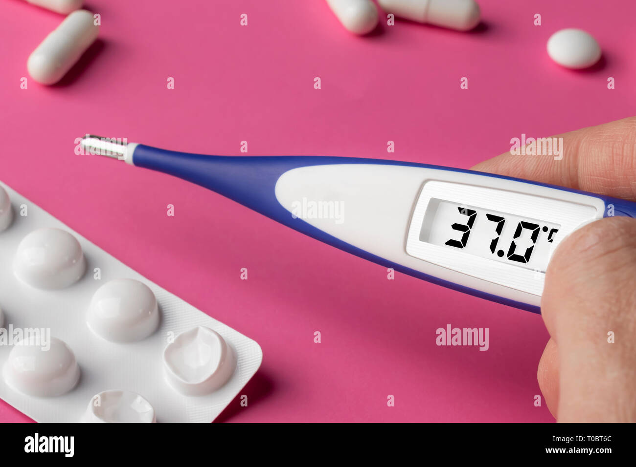 White-blue thermometer with a high temperature of 37.0 degrees Celsius ...