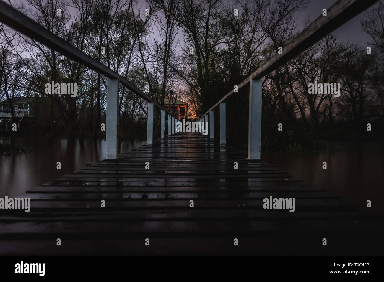 Scary view from the dock of an abandoned lake house, surrounded by the ...