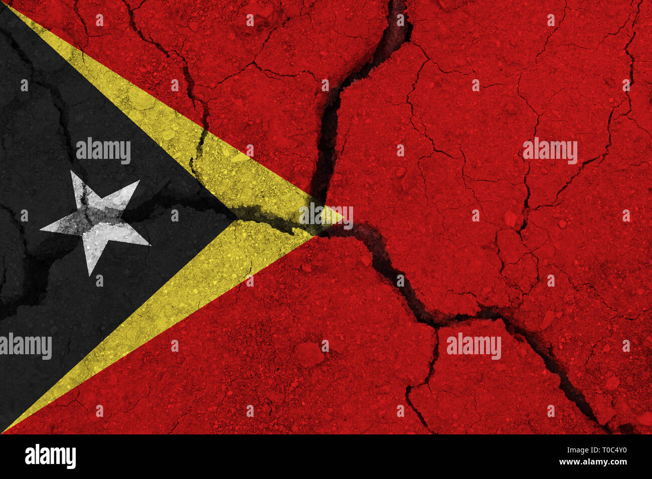East Timor flag on the cracked earth. National flag of East Timor ...