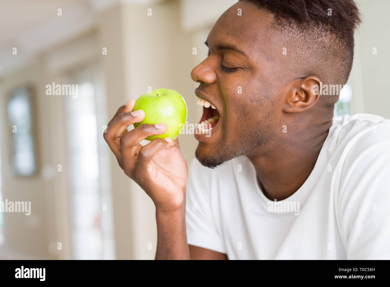 African man holding apple hi-res stock photography and images - Alamy