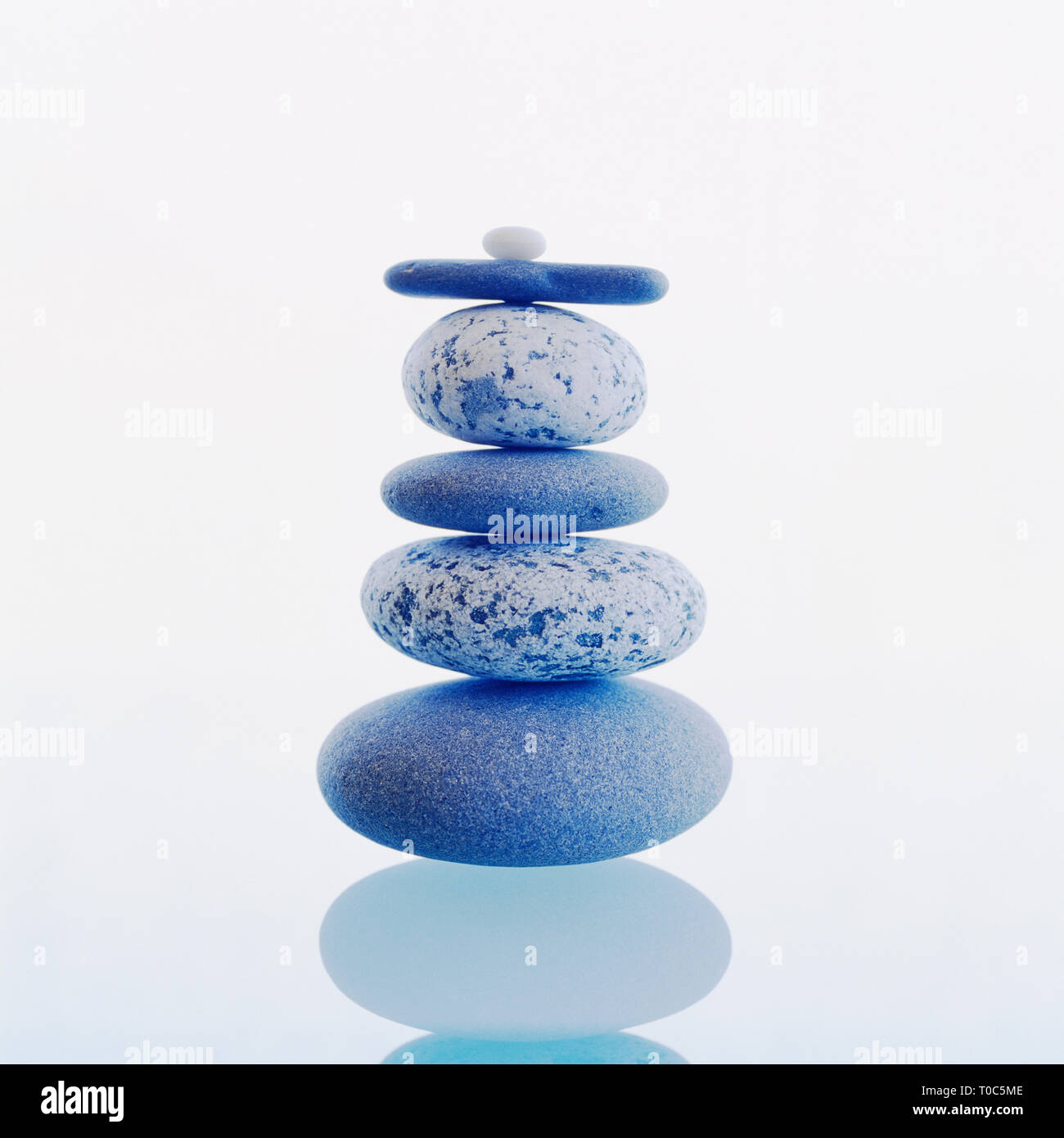 Stack of balanced rocks stones isolated on white background. Meditation ...