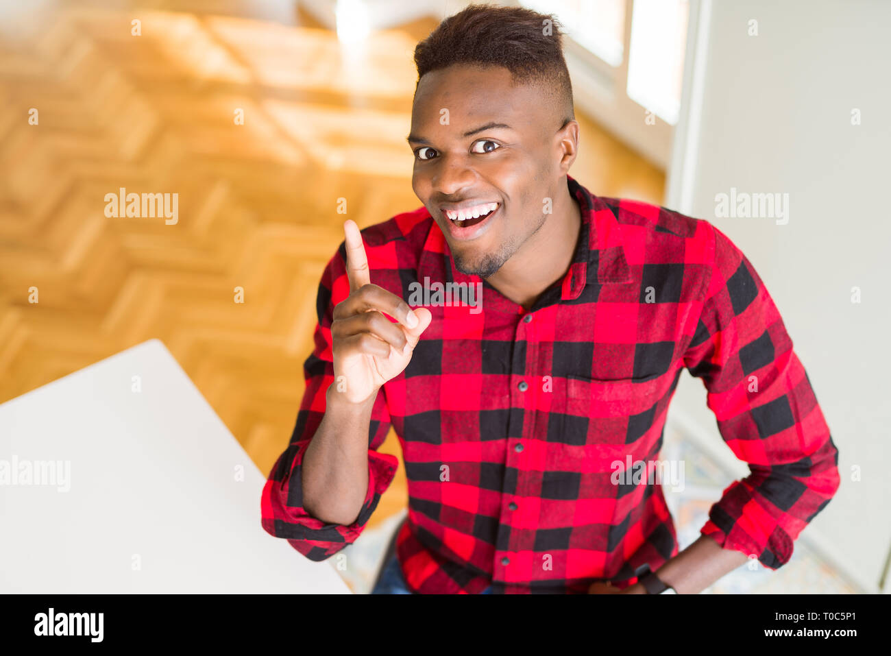 Overhead angle of handsome african american man pointing finger up with ...