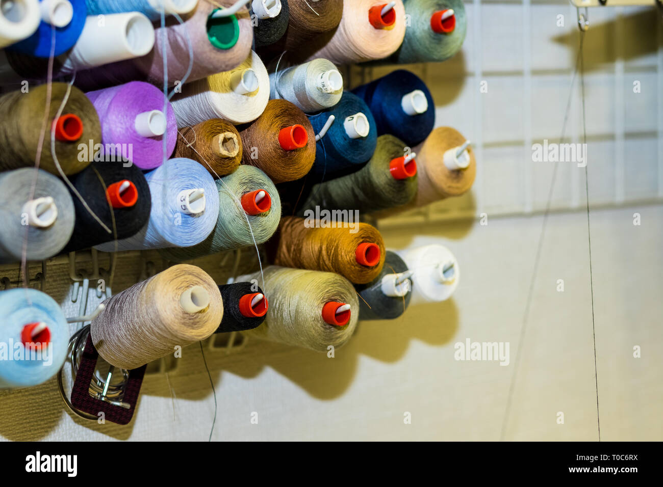 Colorful embroidery thread spool using in garment industry, row of ...