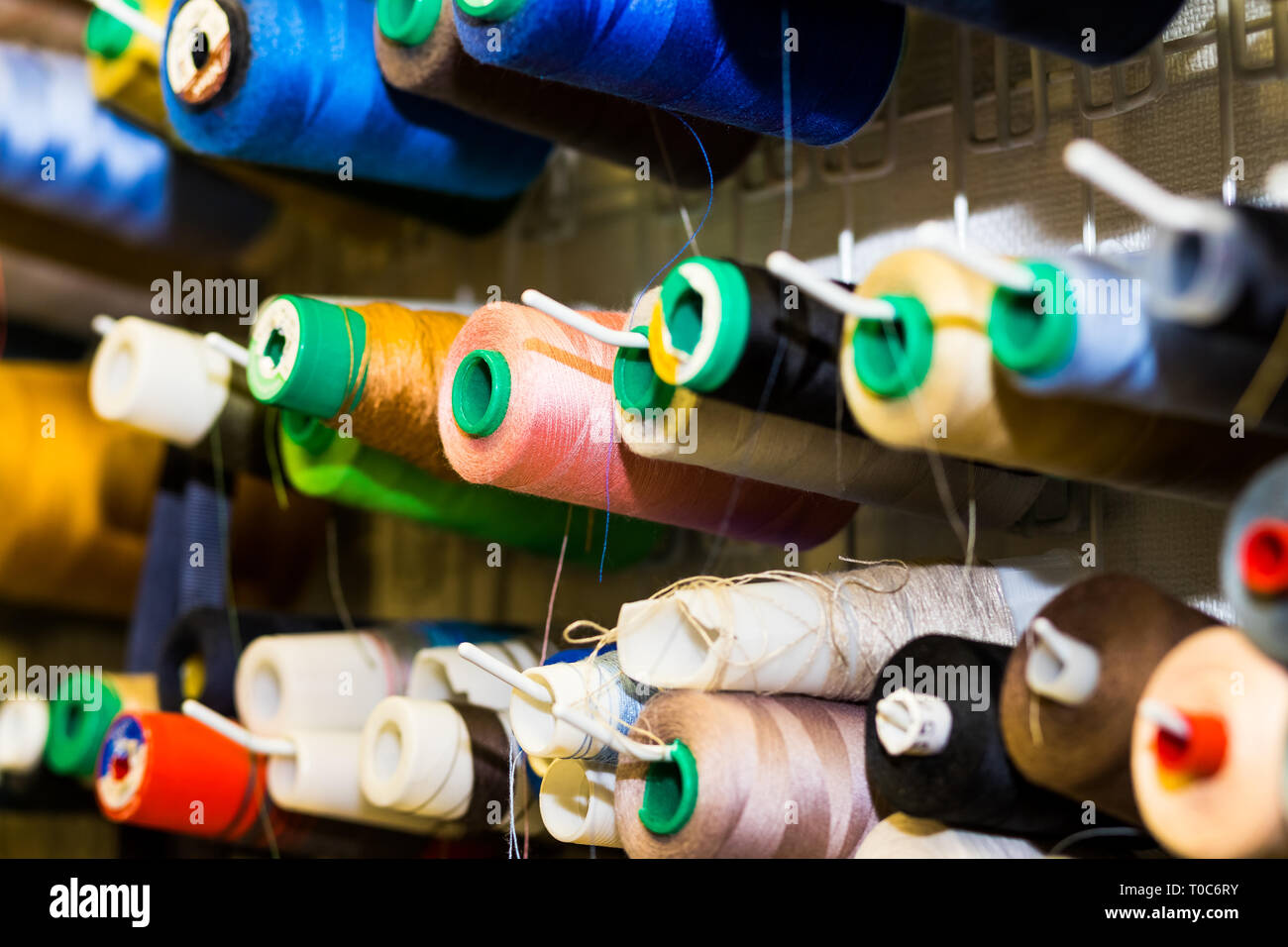 Colorful embroidery thread spool using in garment industry, row of ...
