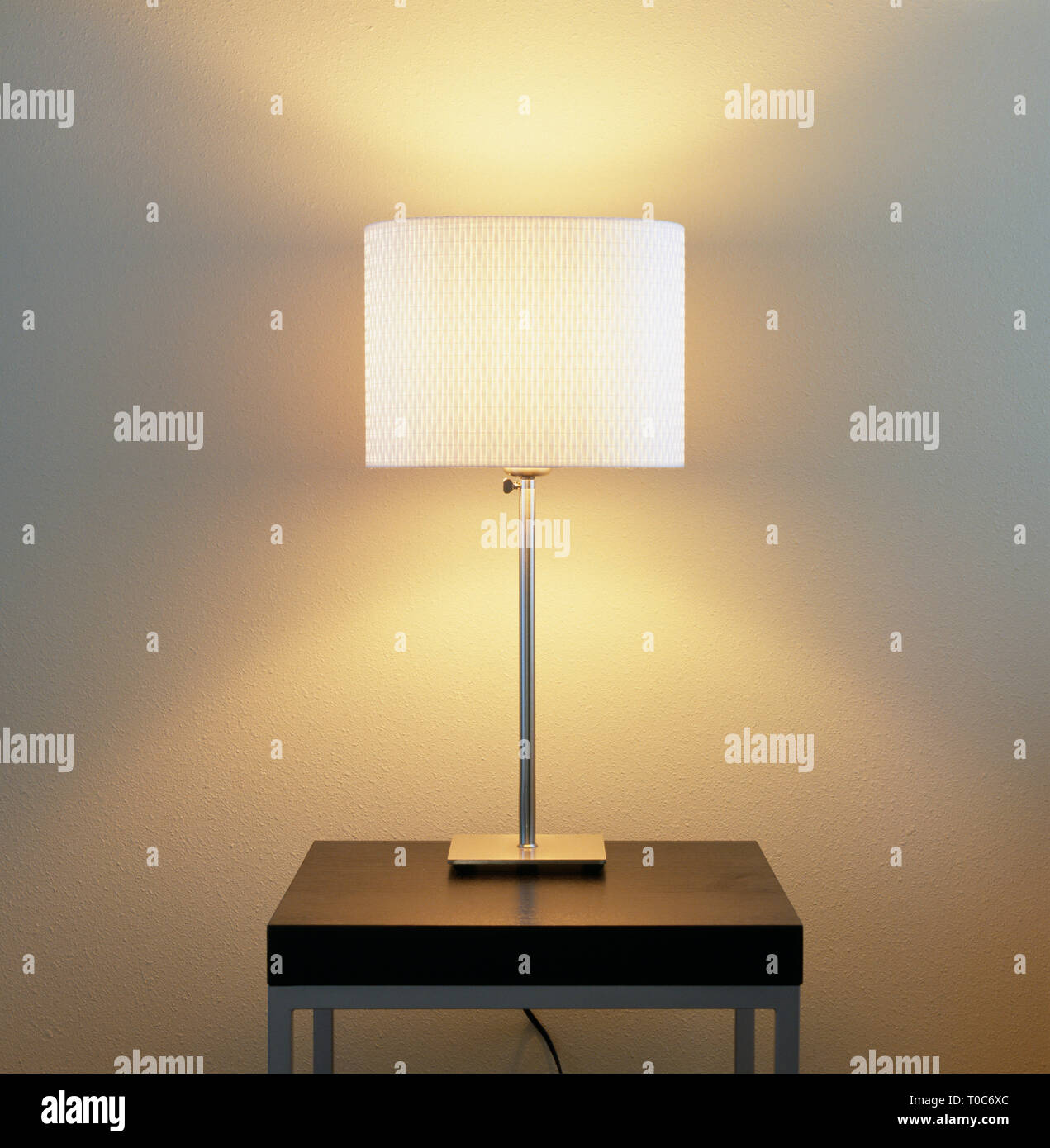 Lamp on table with painted wall background. Home energy utilities ...