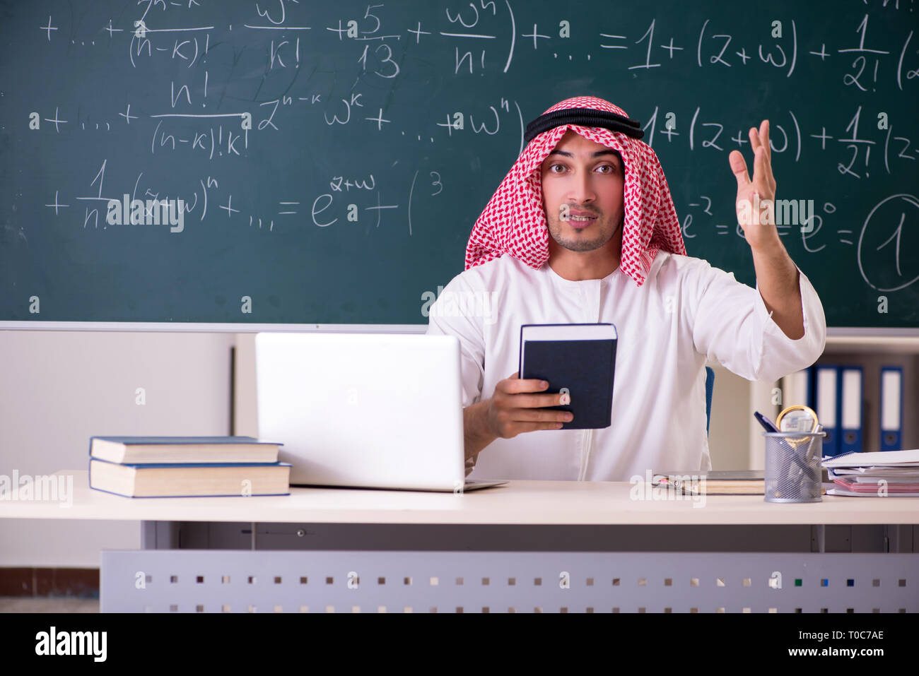 Arab teacher in front of chalkboard Stock Photo - Alamy