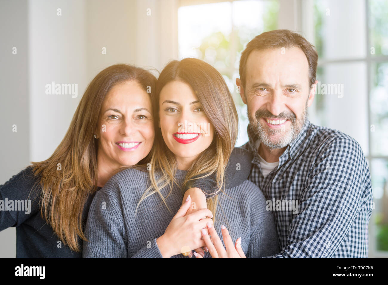 Beautiful family together. Mother, father and daughter smiling and ...