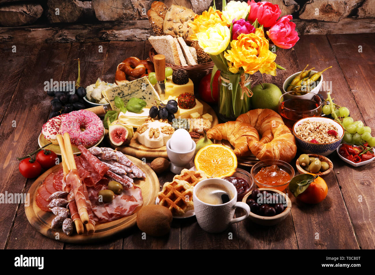 breakfast on table with bread buns, croissants, coffe and donuts Stock ...