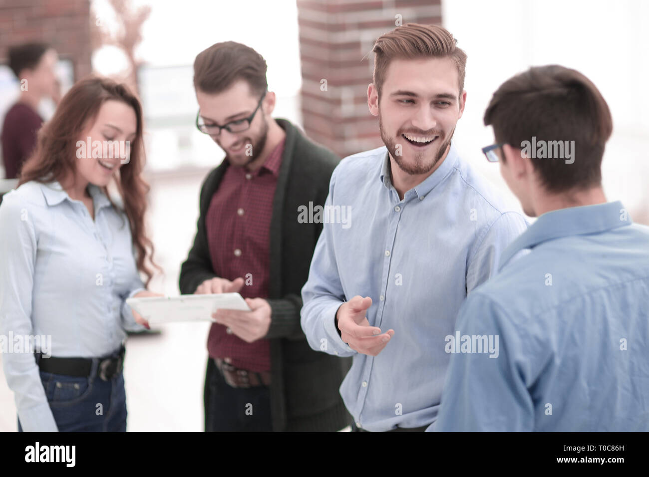 Manager consulting with his colleagues in the office Stock Photo - Alamy
