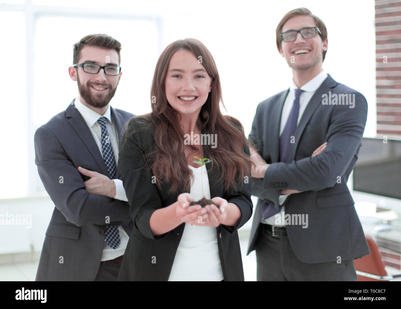 business team with a young sprout looking at the camera Stock Photo - Alamy