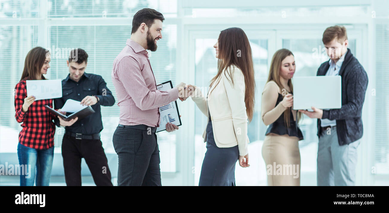 welcome handshake Manager and the client in the lobby of the office ...
