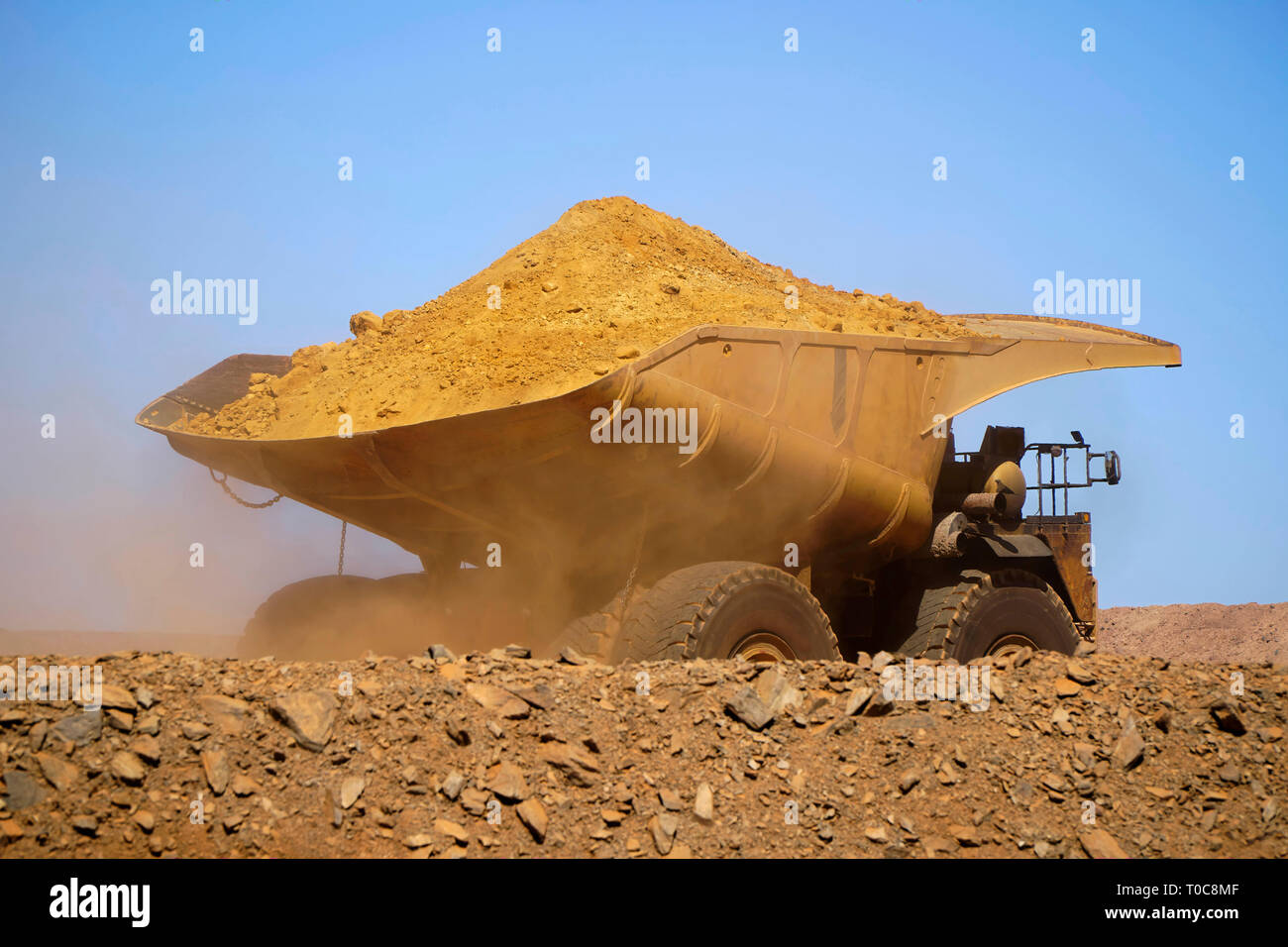 Gold mine operation in open gold mine pit with large haul truck leaving ...
