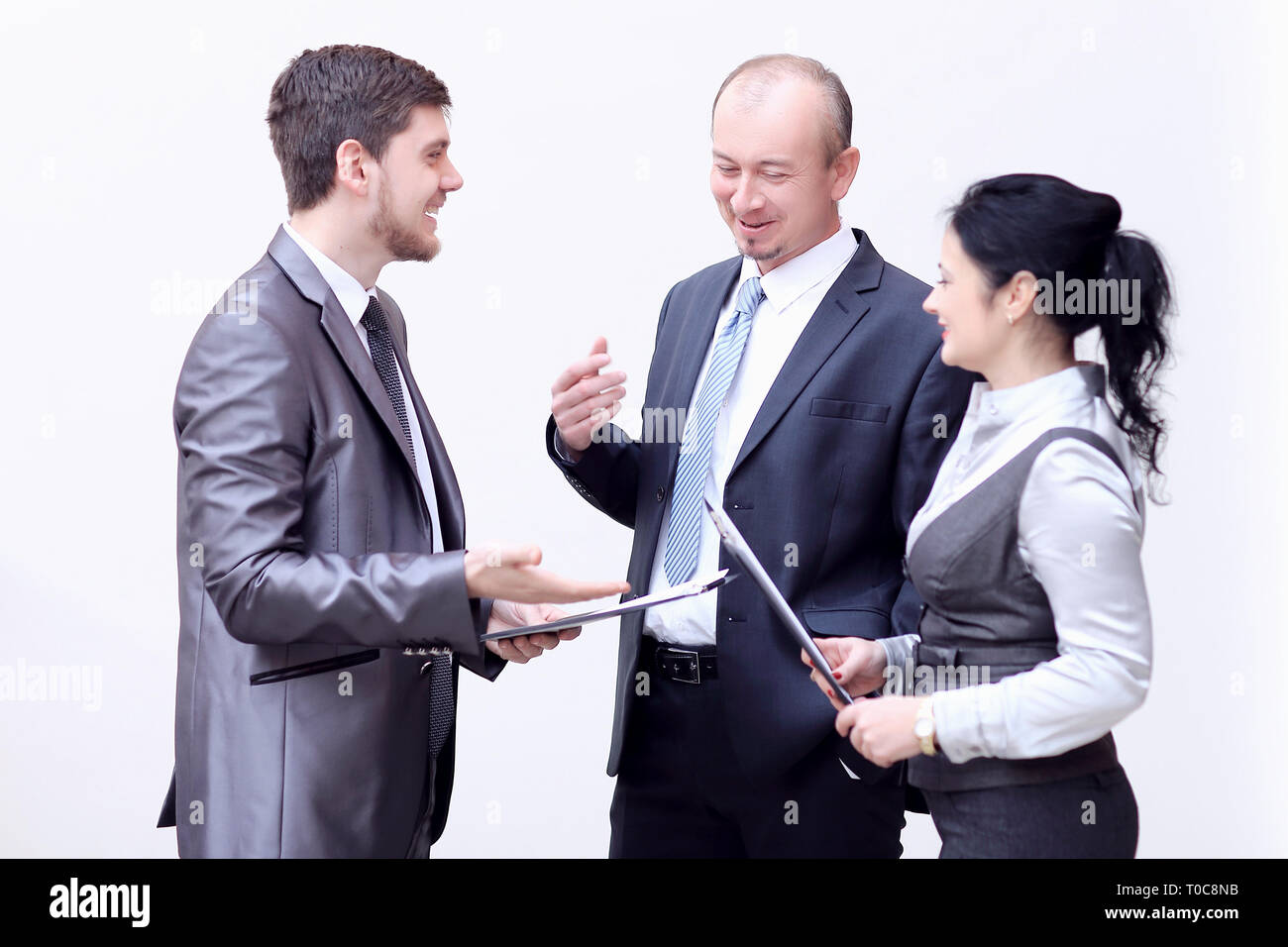 staff discuss business documents,standing in the lobby of the office ...