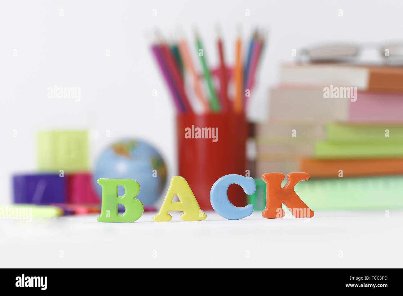 word back on blurred background school supplies .photo with copy space ...