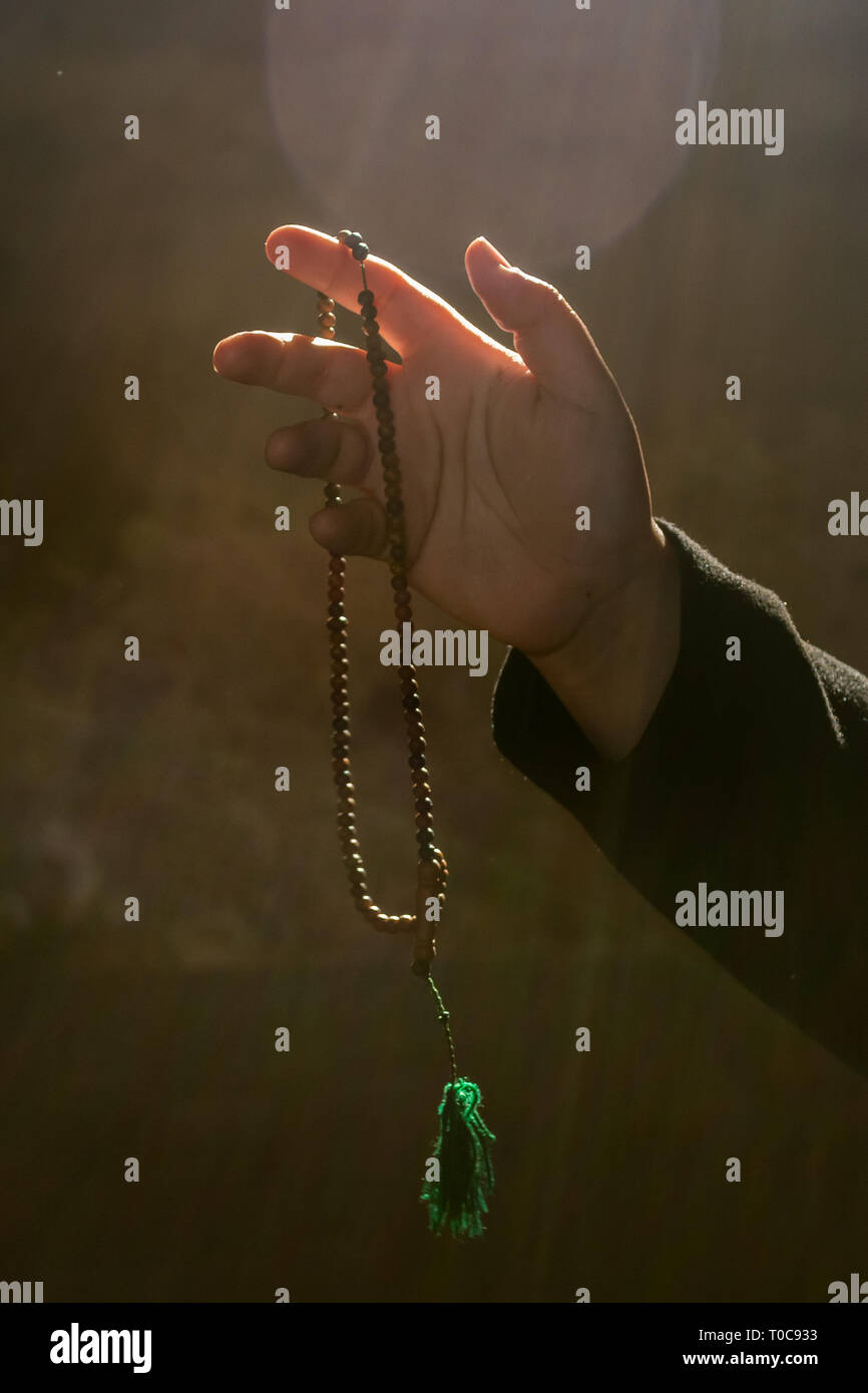 hand holding a Muslim rosary (sebha Stock Photo - Alamy