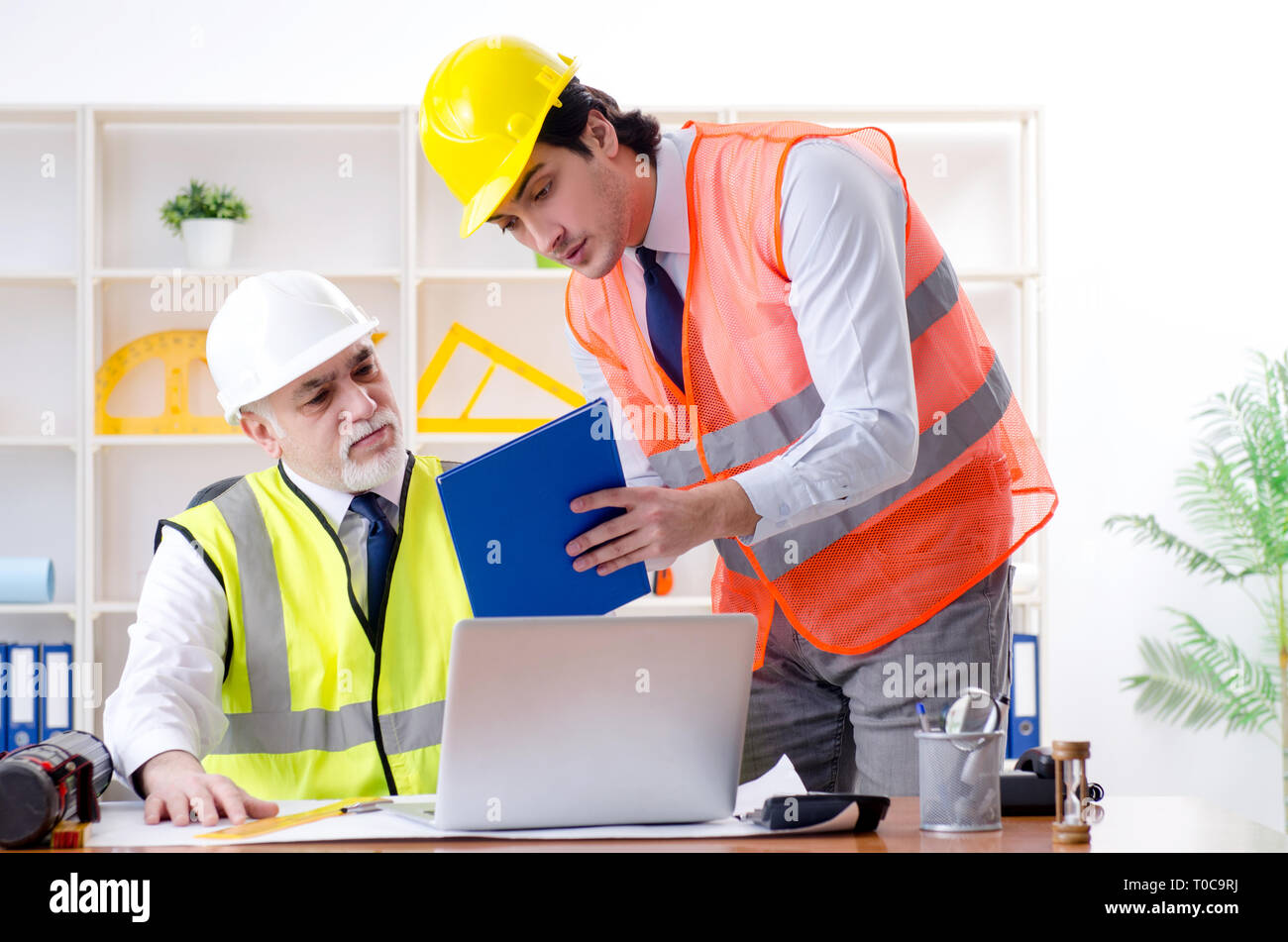 Two engineers colleagues working under project Stock Photo - Alamy