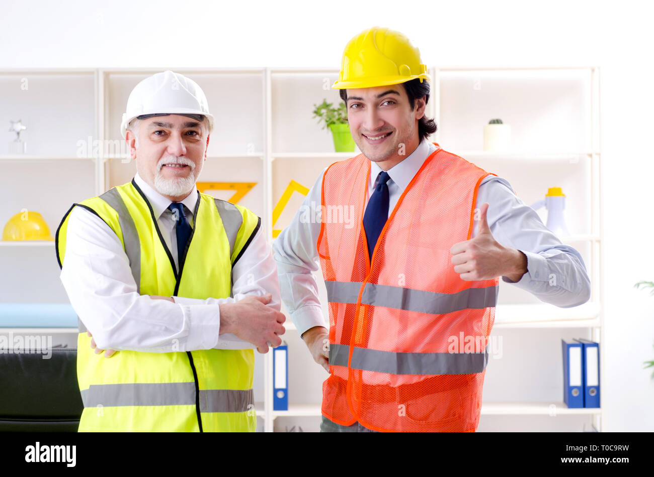 Two engineers colleagues working under project Stock Photo - Alamy