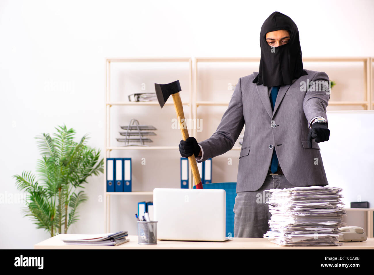 Male gangster stealing information from the office Stock Photo - Alamy