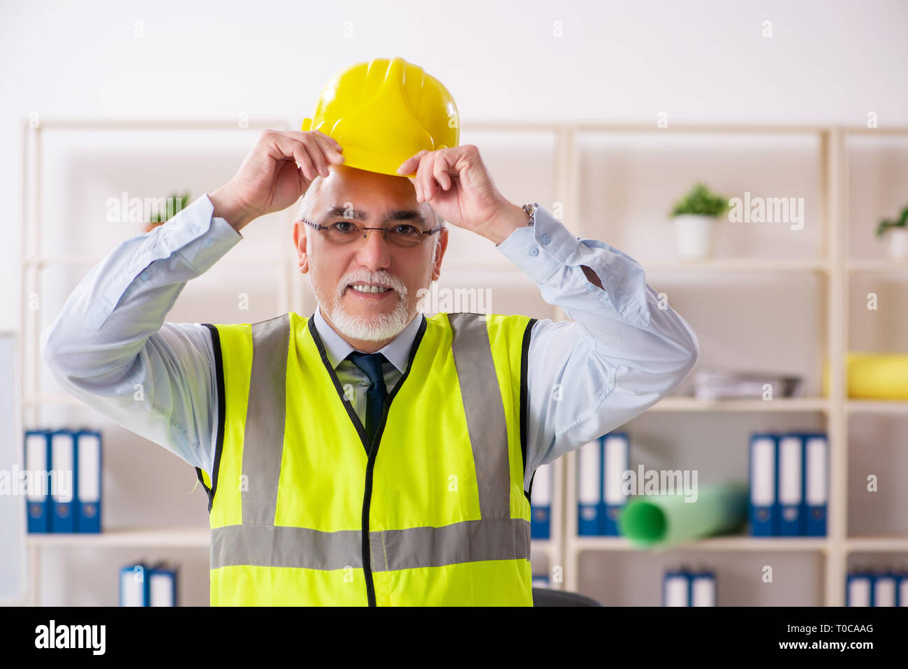 Aged construction engineer working in the office Stock Photo - Alamy