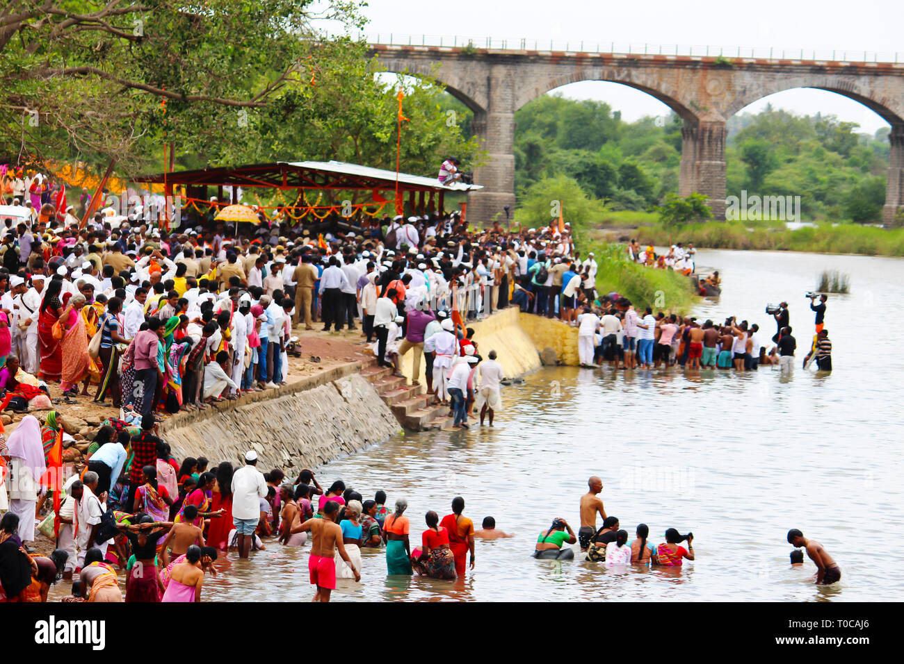 MAHARASHTRA, INDIA, July 2015, people bathing at Nira river ...