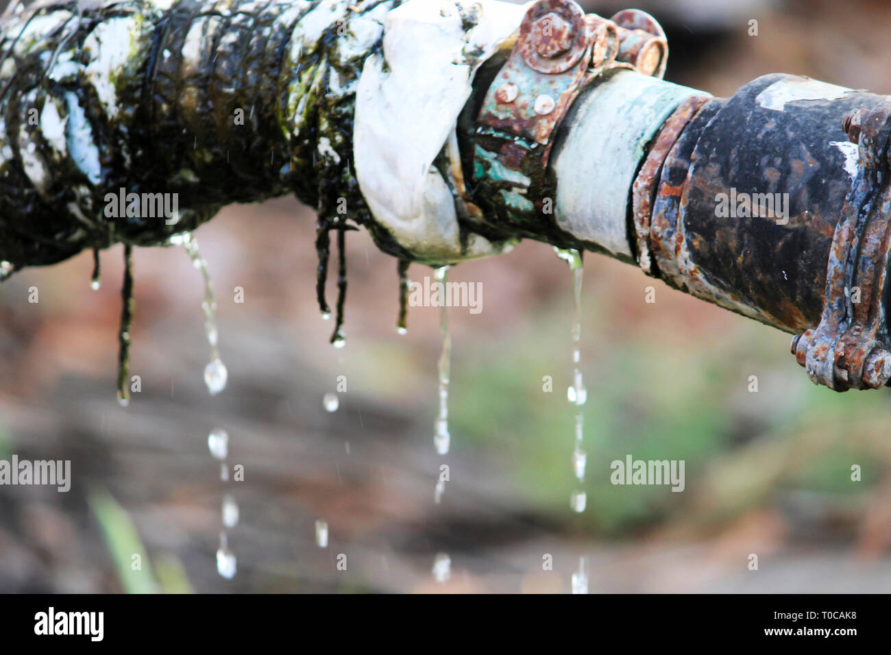 Pipe with water leakage, India. Water dripping off damaged pipes Stock ...