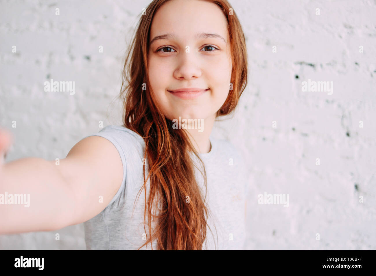 Beautiful charming redhead smiling teenager girl taking selfie on ...