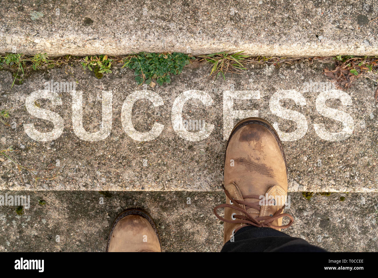 Man stepping up a stairs with word SUCCESS Stock Photo - Alamy