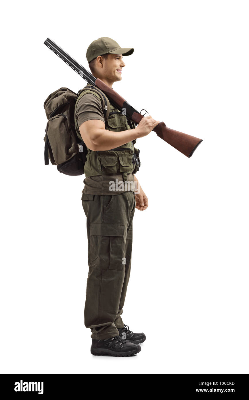 Full length profile shot of a young male hunter standing with a shotgun ...