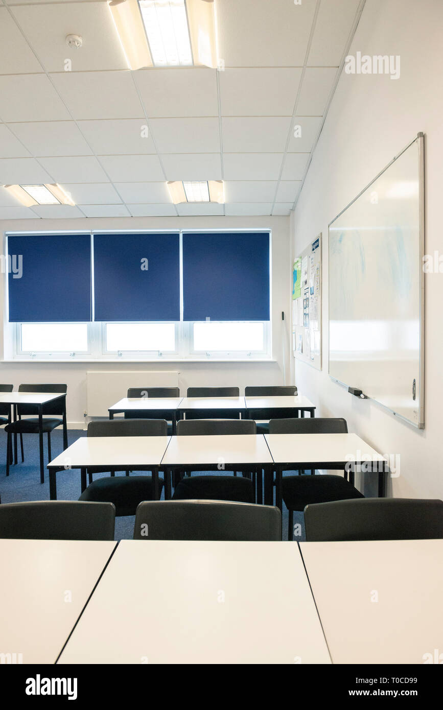 Empty classrooms at a school / college / university with desks, tables ...