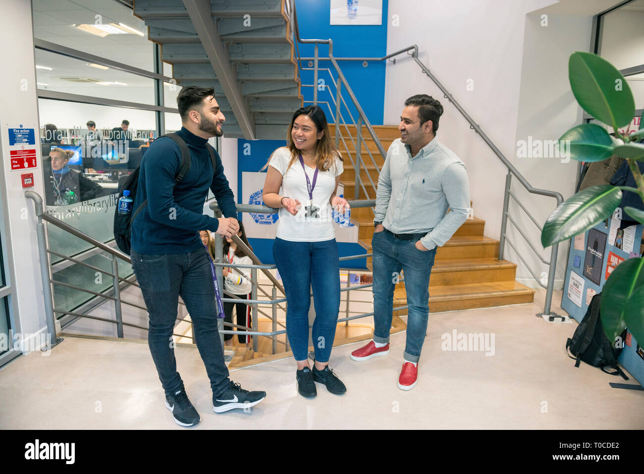 students / pupils stand in the hallway / stairwell of their college ...