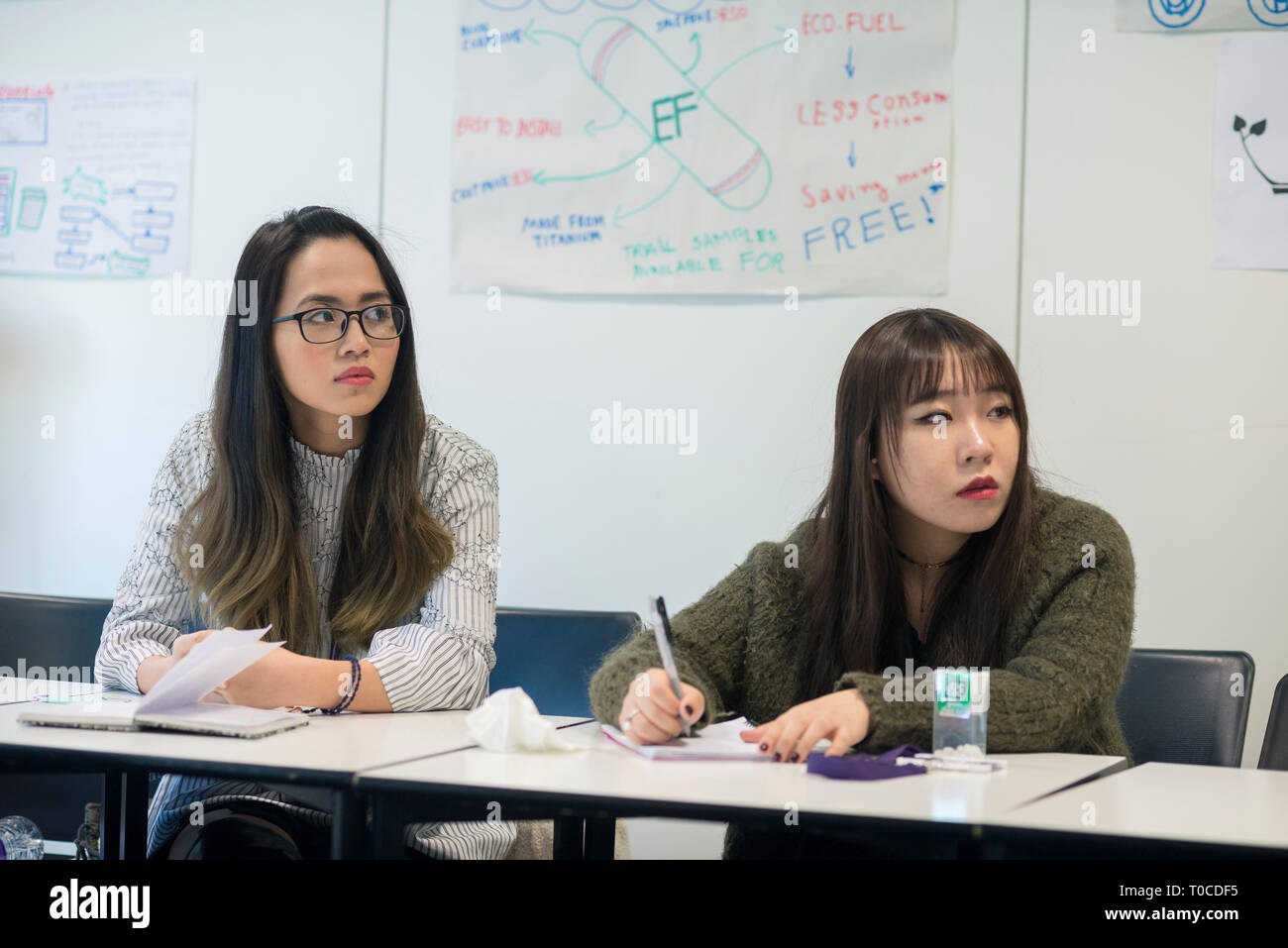 pupils and students in a classroom at a college / university, being ...