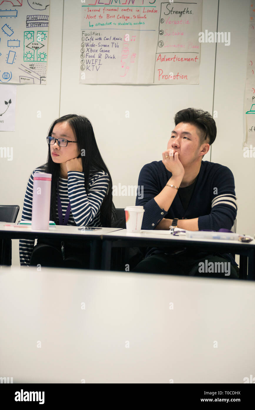 pupils and students in a classroom at a college / university, being ...