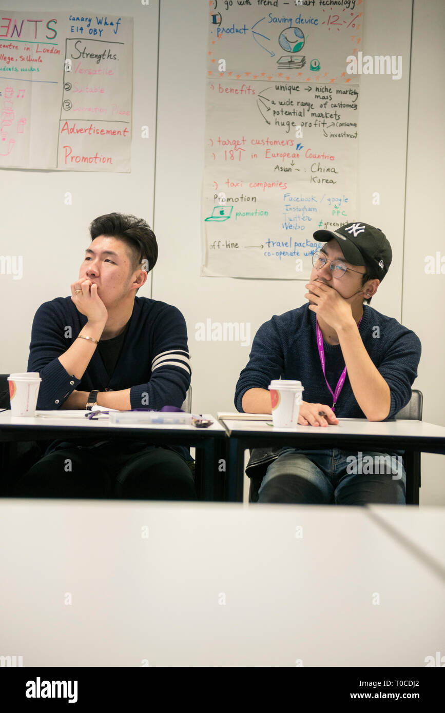 pupils and students in a classroom at a college / university, being ...